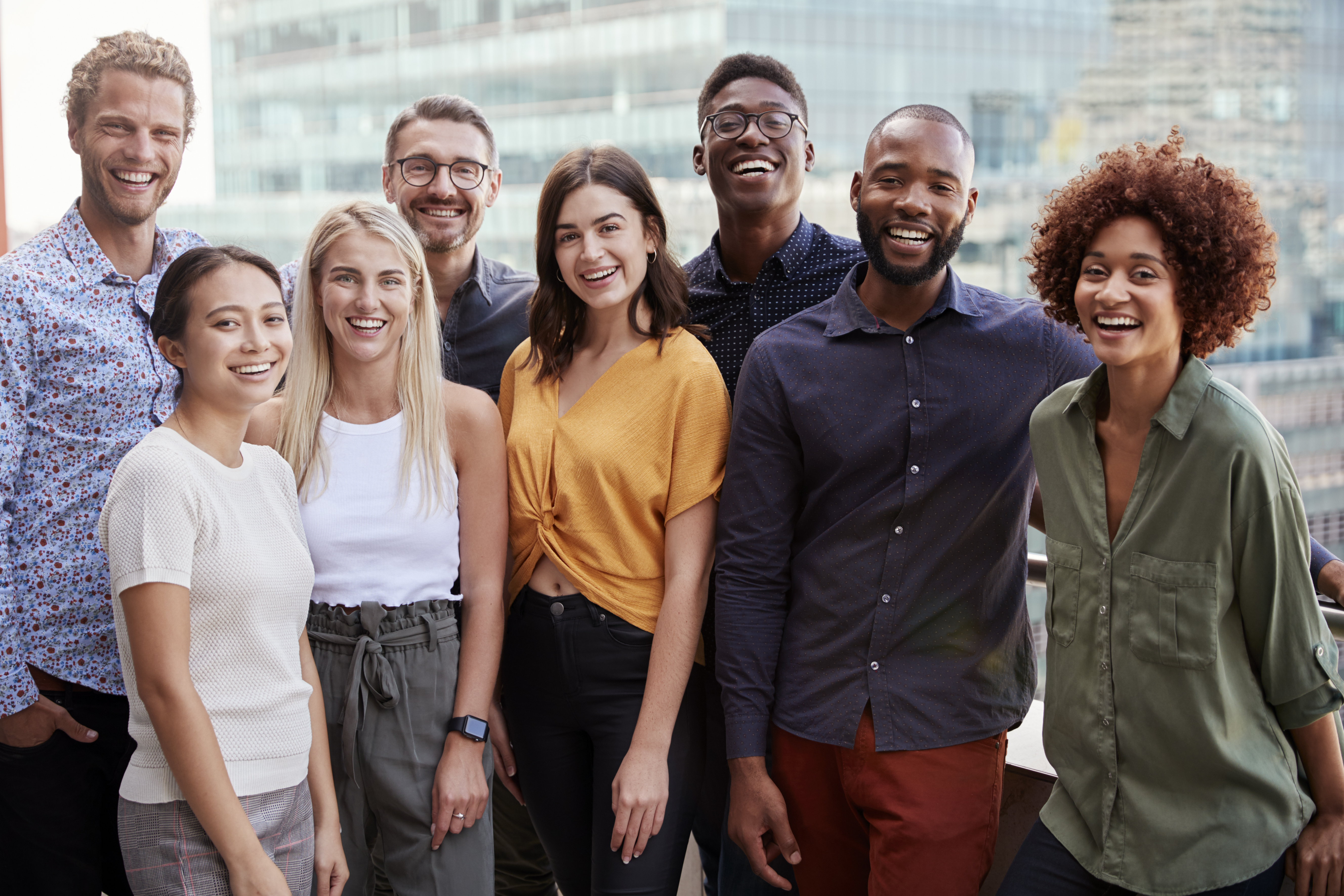 Group portrait of a creative business team standing outdoors, three ...